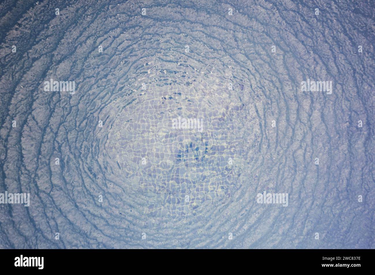 Abstract blue water ripple wave background with pool tiles in middle ...