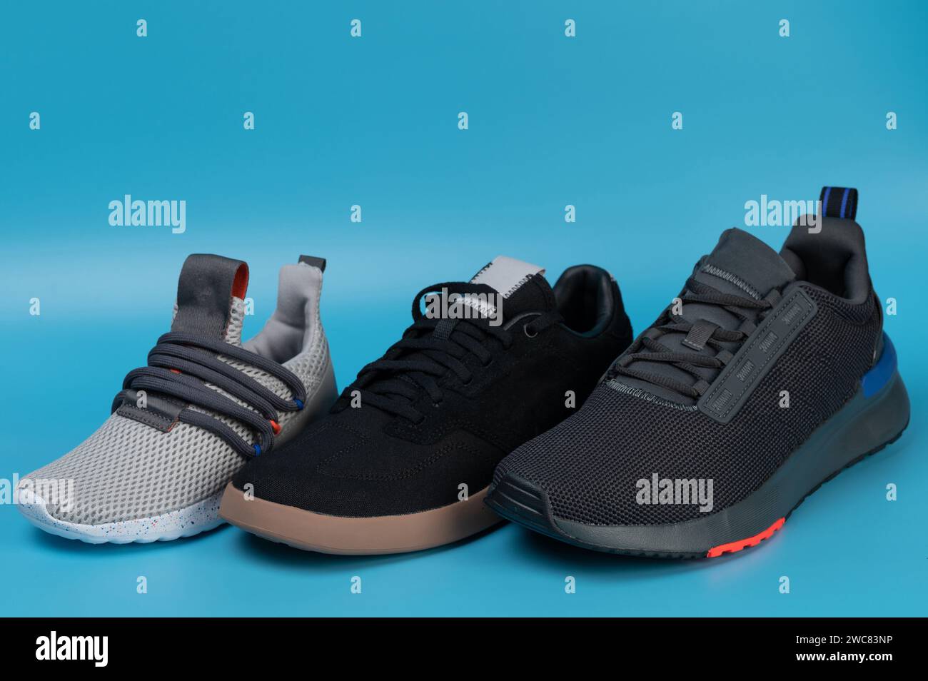 Line of sneakers shoes isolated on blue studio background Stock Photo ...