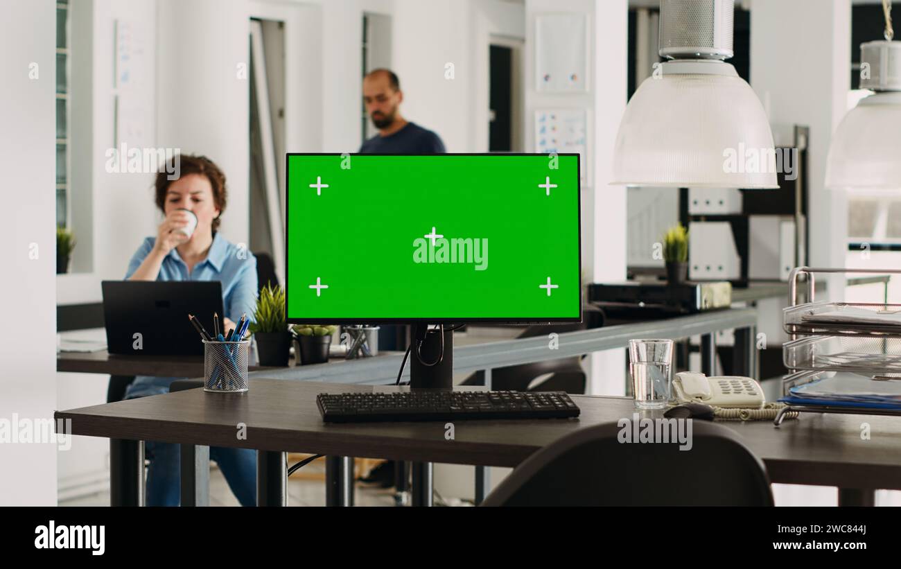 Monitor with greenscreen on empty desk in modern coworking space, pc ...