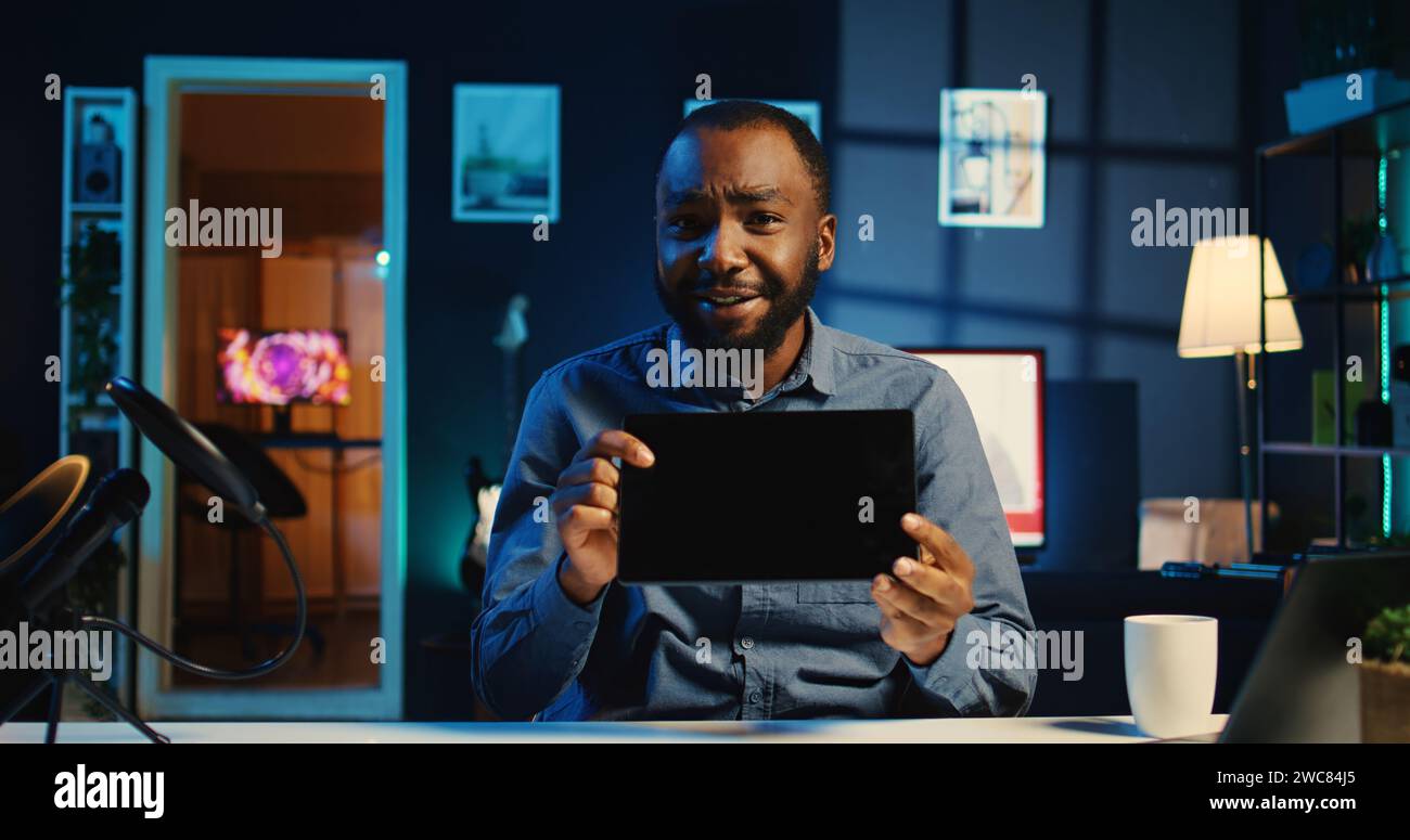 Content creator filming tech review of newly launched tablet, unboxing ...
