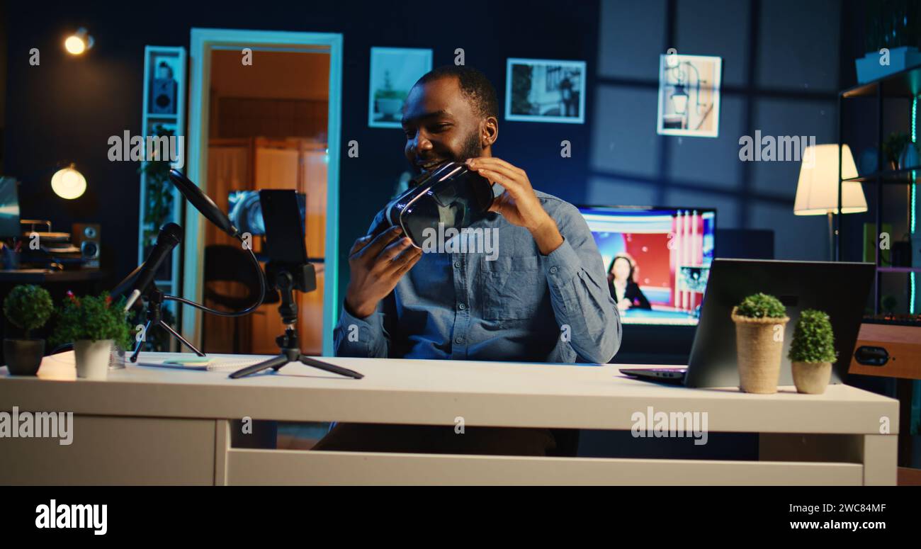 Tech influencer filming sponsored branded content, unboxing newly ...