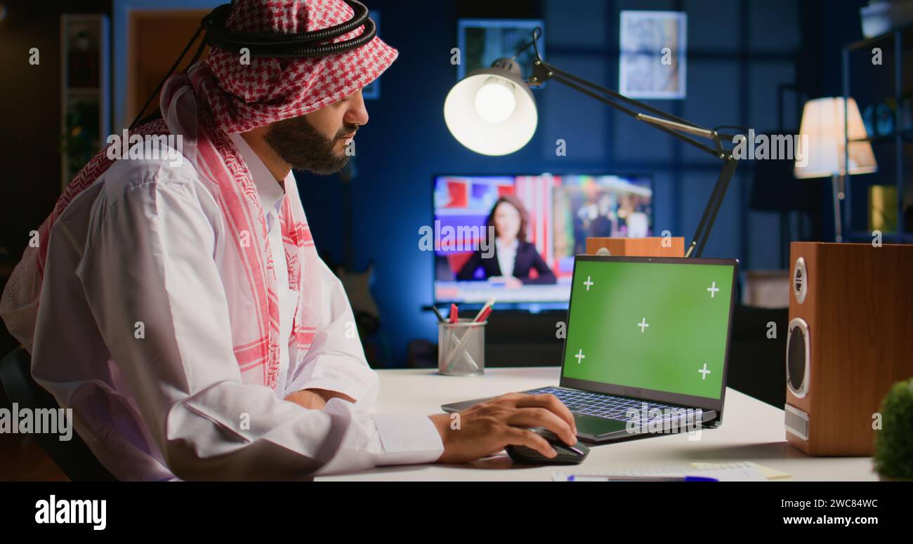 Muslim man scrolling on isolated screen laptop, checking social media ...