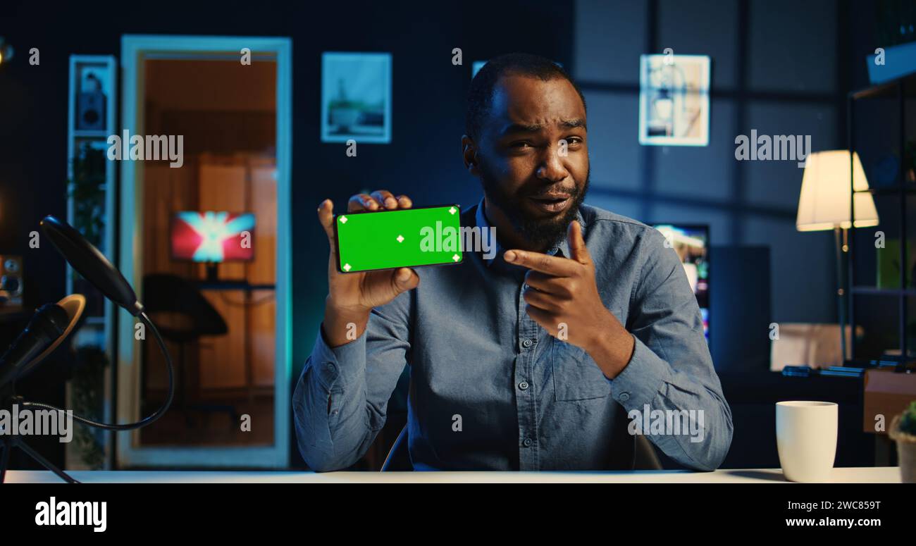 Content creator holding chroma key product, being sponsored by tech ...