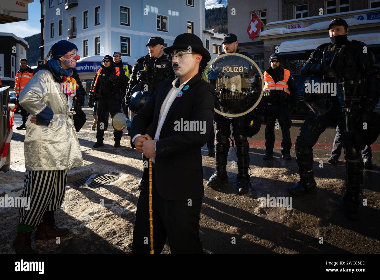 Davos, Switzerland. 14th Jan, 2024. Riot police monitor the rally ...