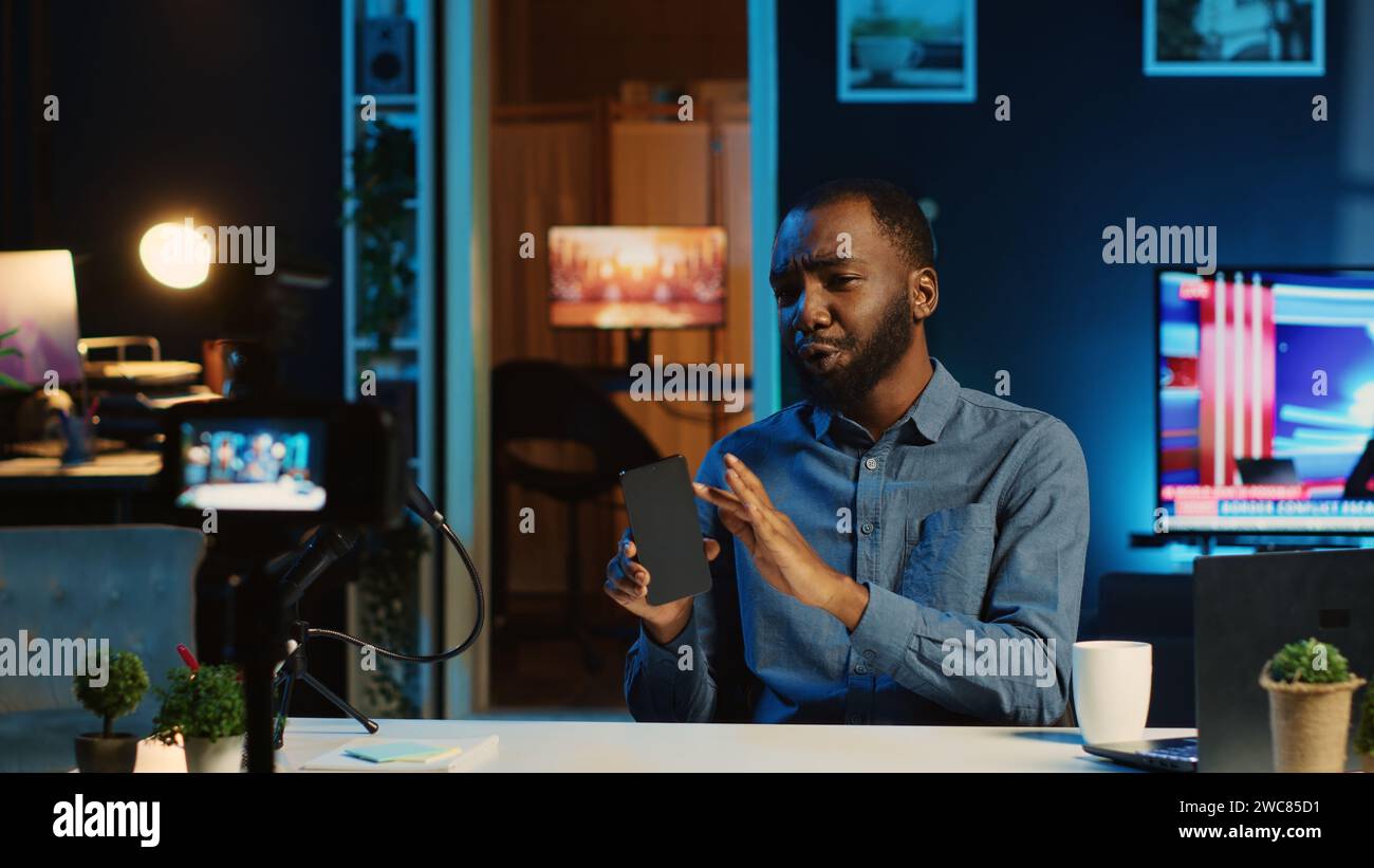 African american tech content creator filming review of newly released ...