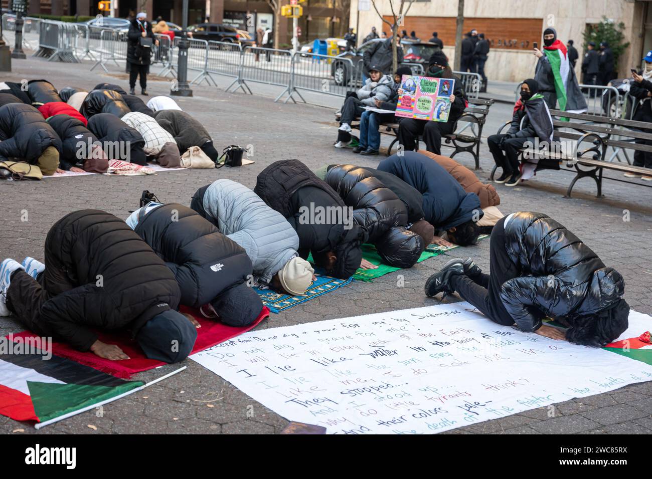 New York, New York, USA. 14th Jan, 2024. Demonstrators take a moment ...