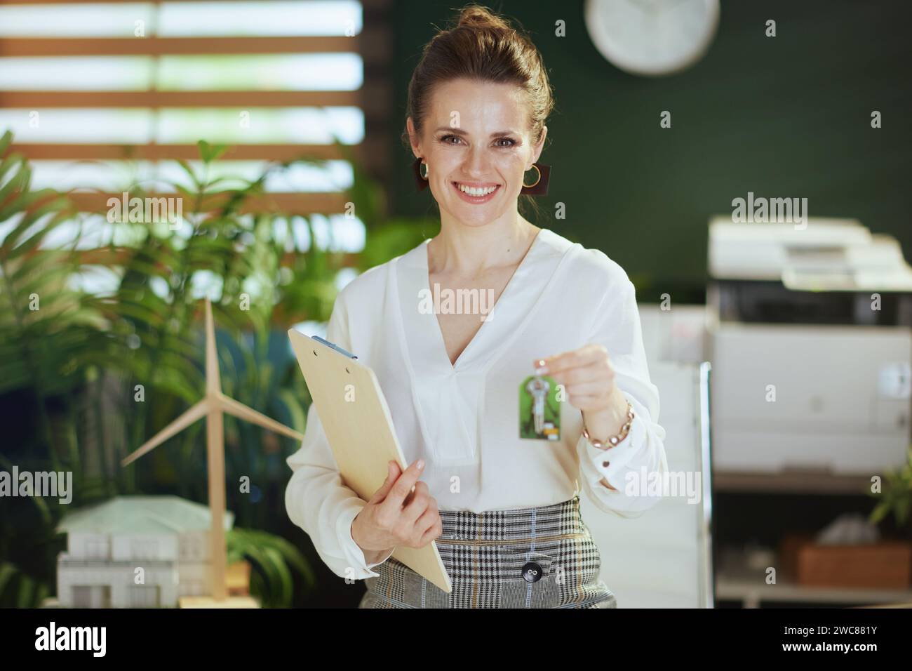 Time to move on. happy modern middle aged woman realtor in modern green ...