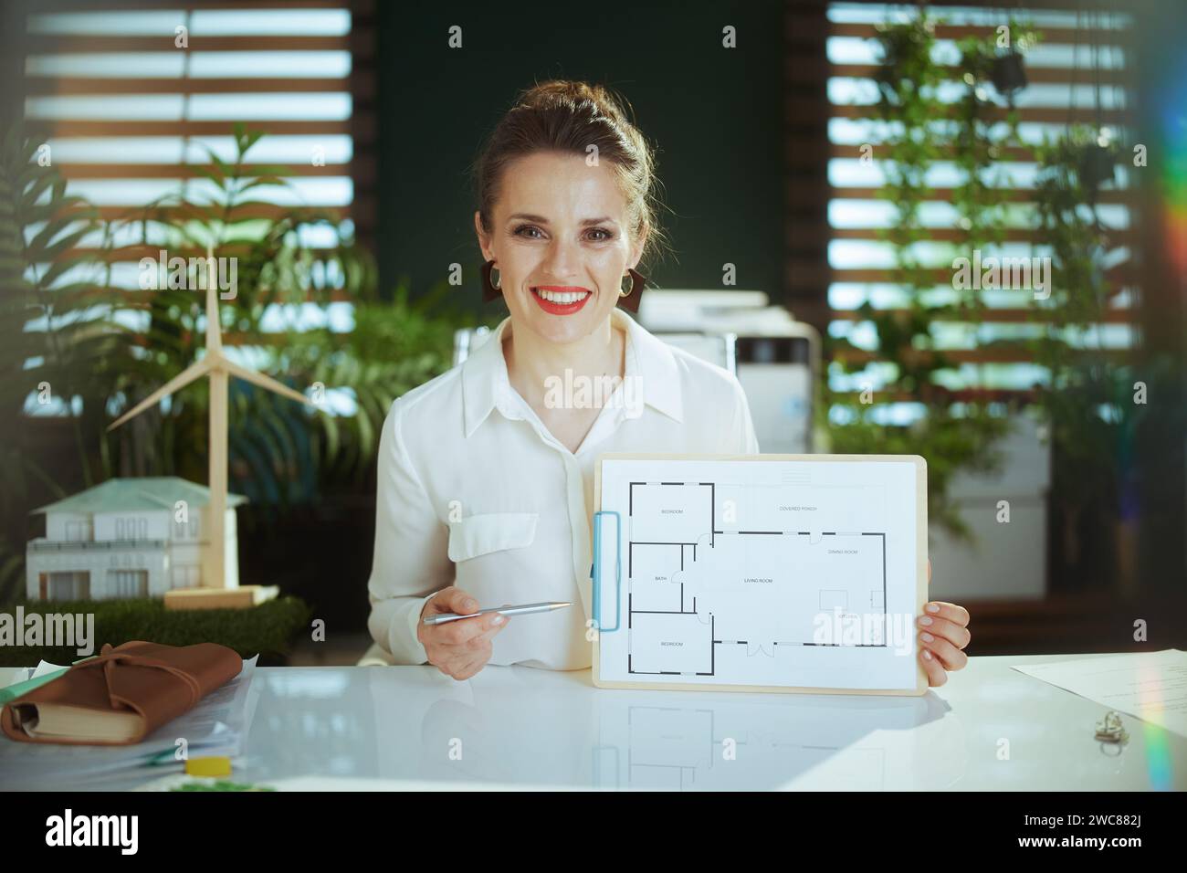 Sustainable real estate business. smiling young female realtor in ...