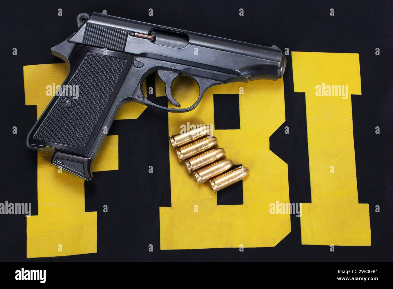 FBI concept with handgun and ammunition on black uniform background ...
