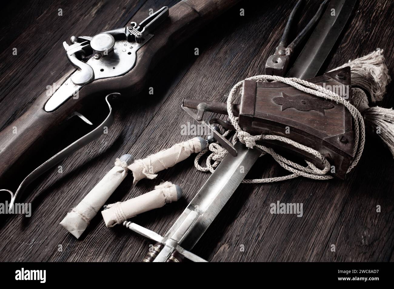 flintlock musket with powder flask and led bullets on wooden deck Stock ...