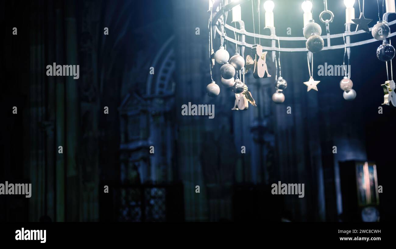 A dimly lit photograph captures an ornate chandelier adorned with ...