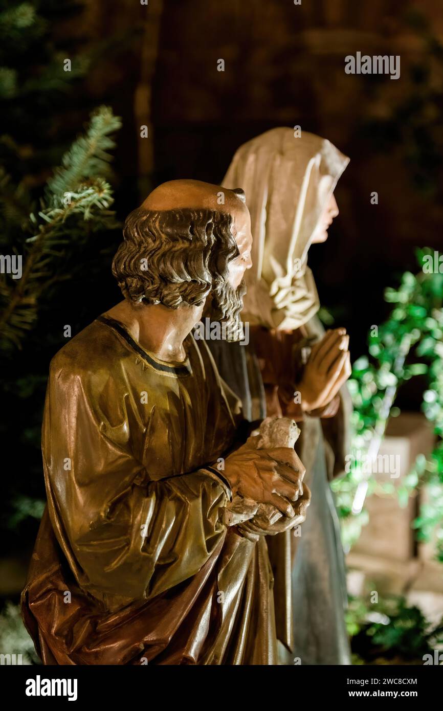 An intricately detailed statue of Joseph and Mary, highlighted by ...