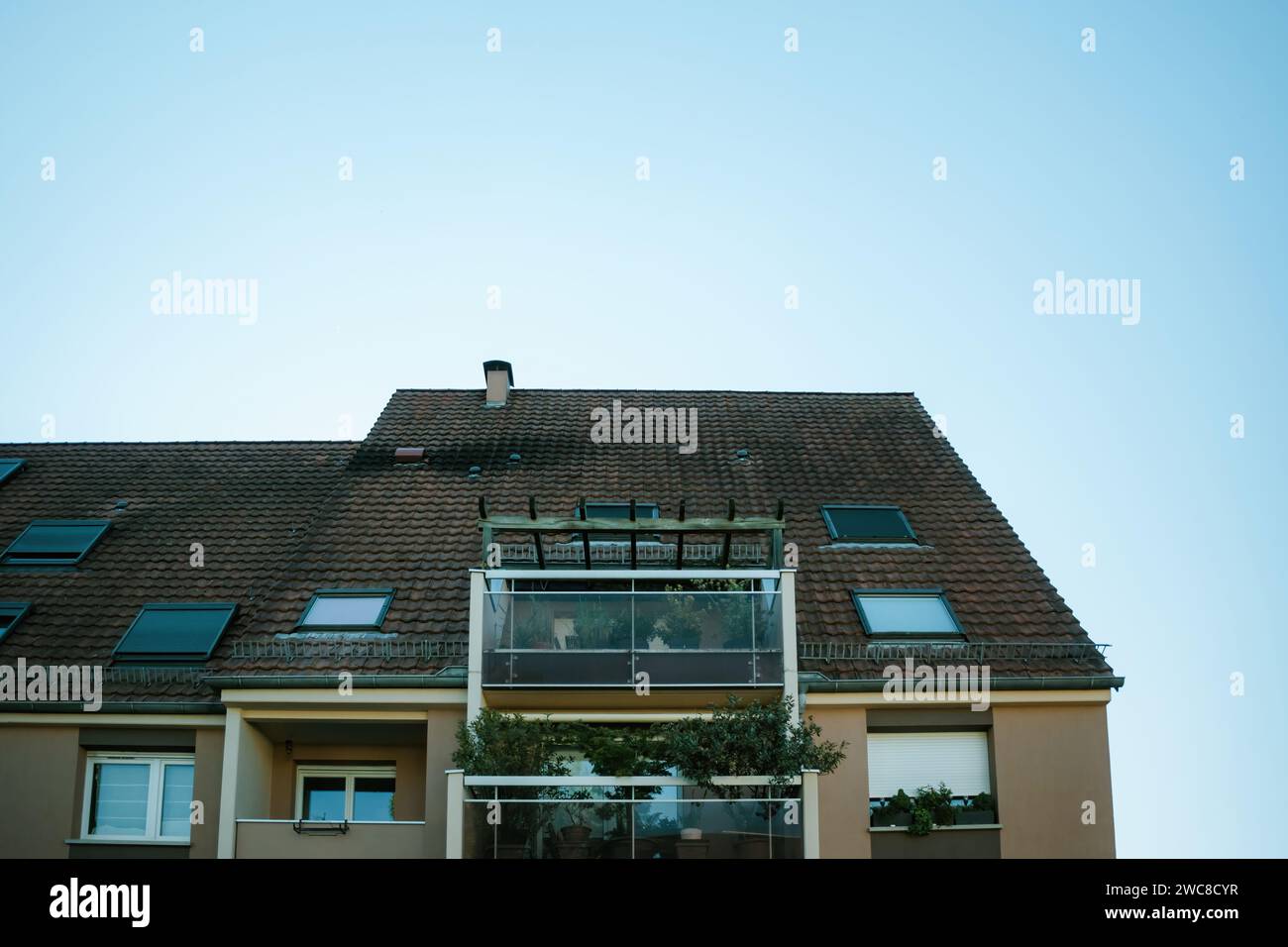 An imposing apartment building featuring a prominent balcony and ...