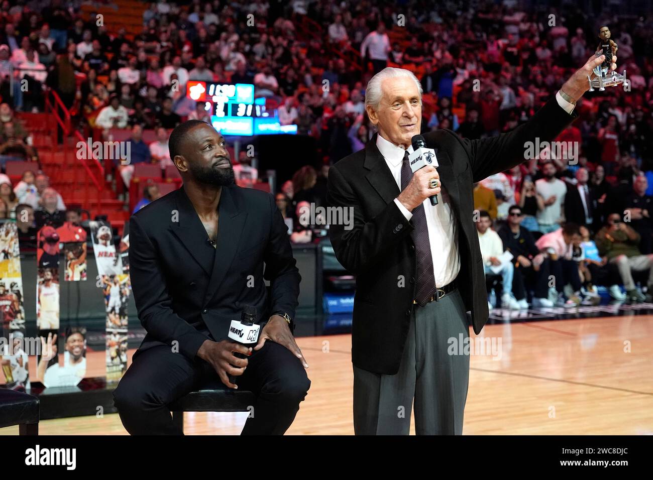 Former Miami Heat player Dwyane Wade, left, looks on as Heat President ...