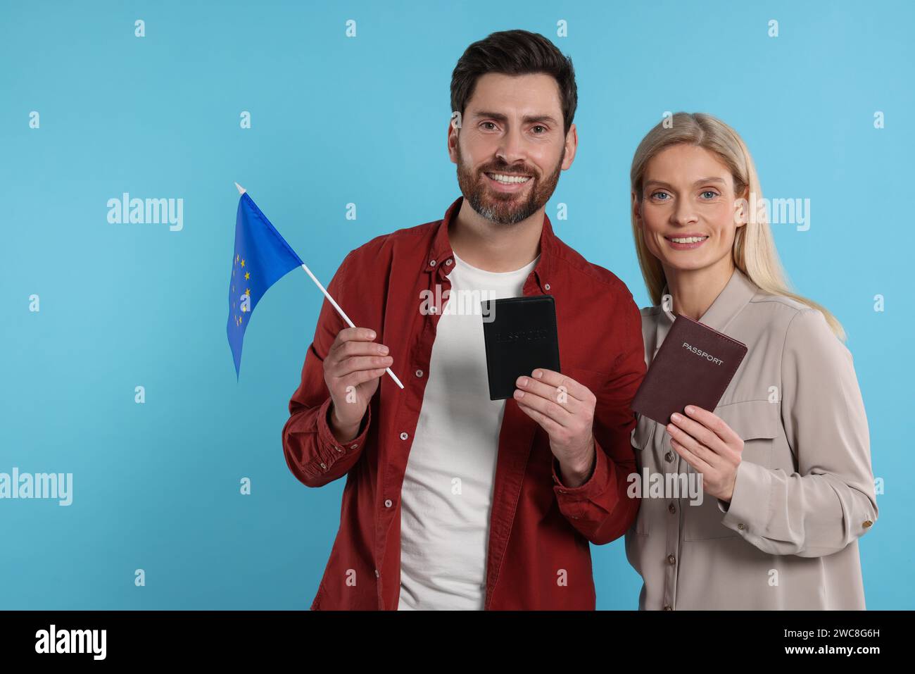 Immigration. Happy couple with passports and flag of European Union on ...