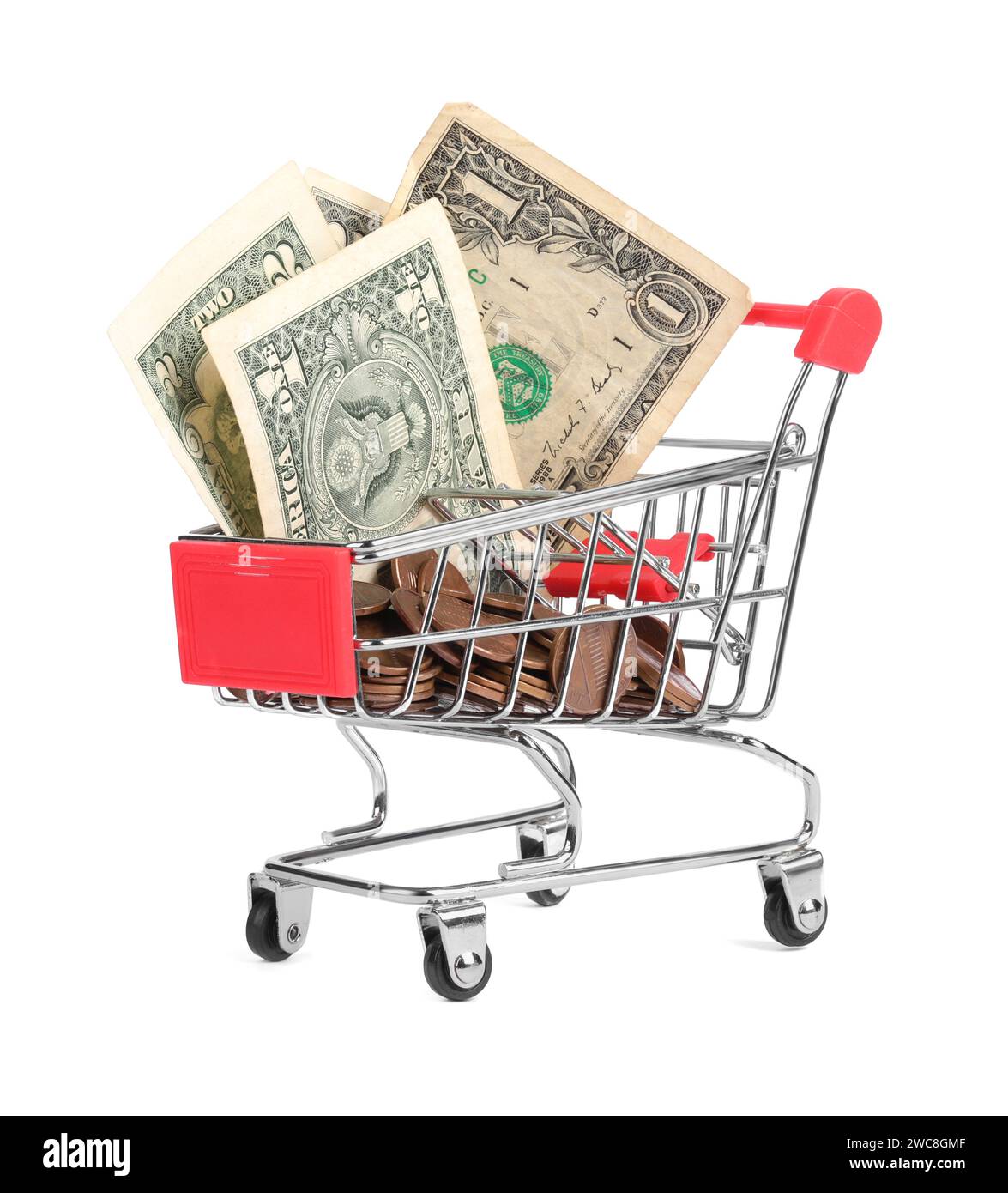 Small metal shopping cart with dollar bills and coins isolated on white ...