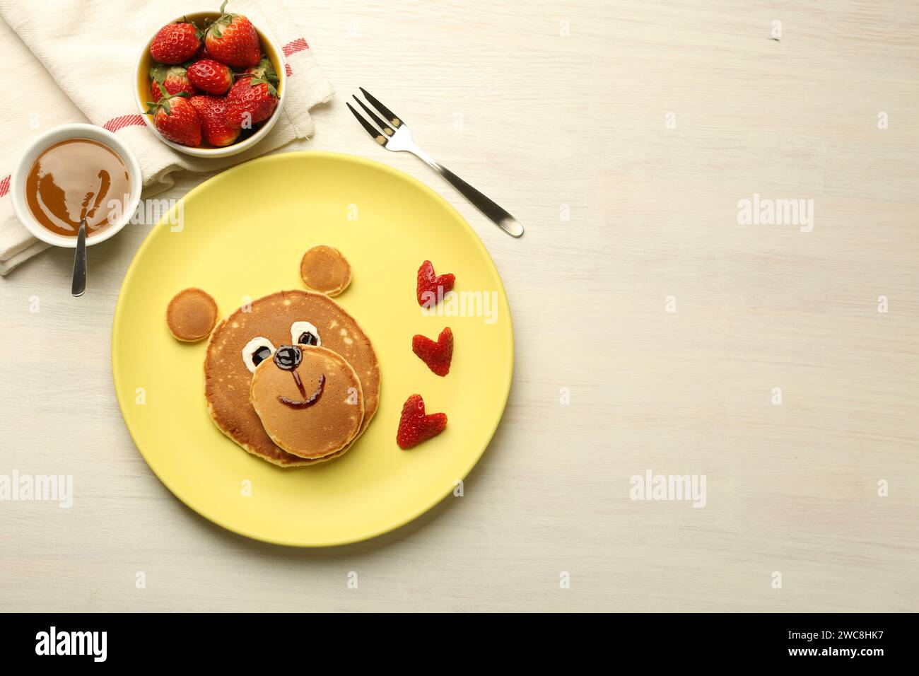 Creative serving for kids. Plate with strawberries, cute bear made of ...