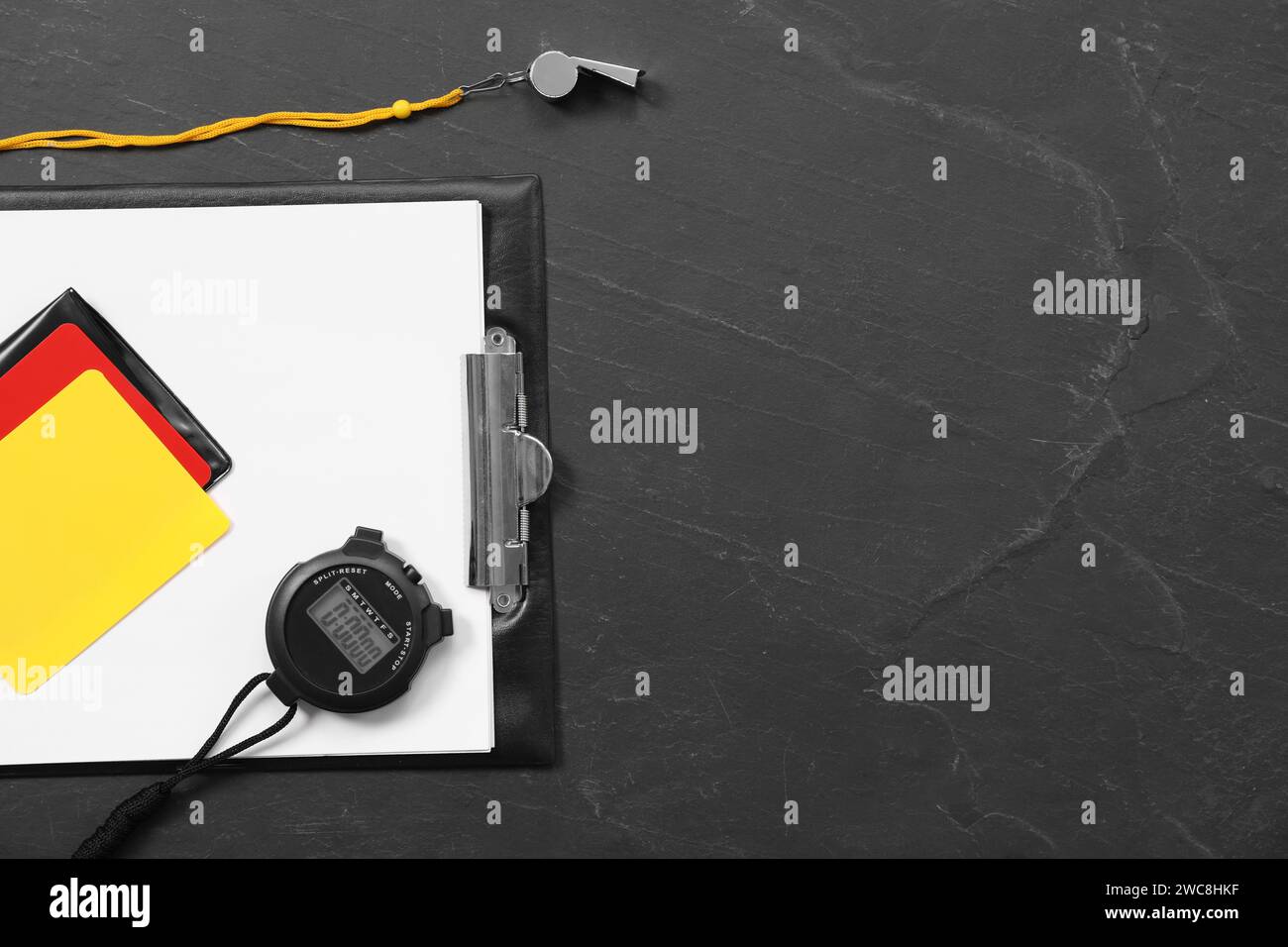 Referee equipment. Whistle, clipboard, cards and stopwatch on black ...