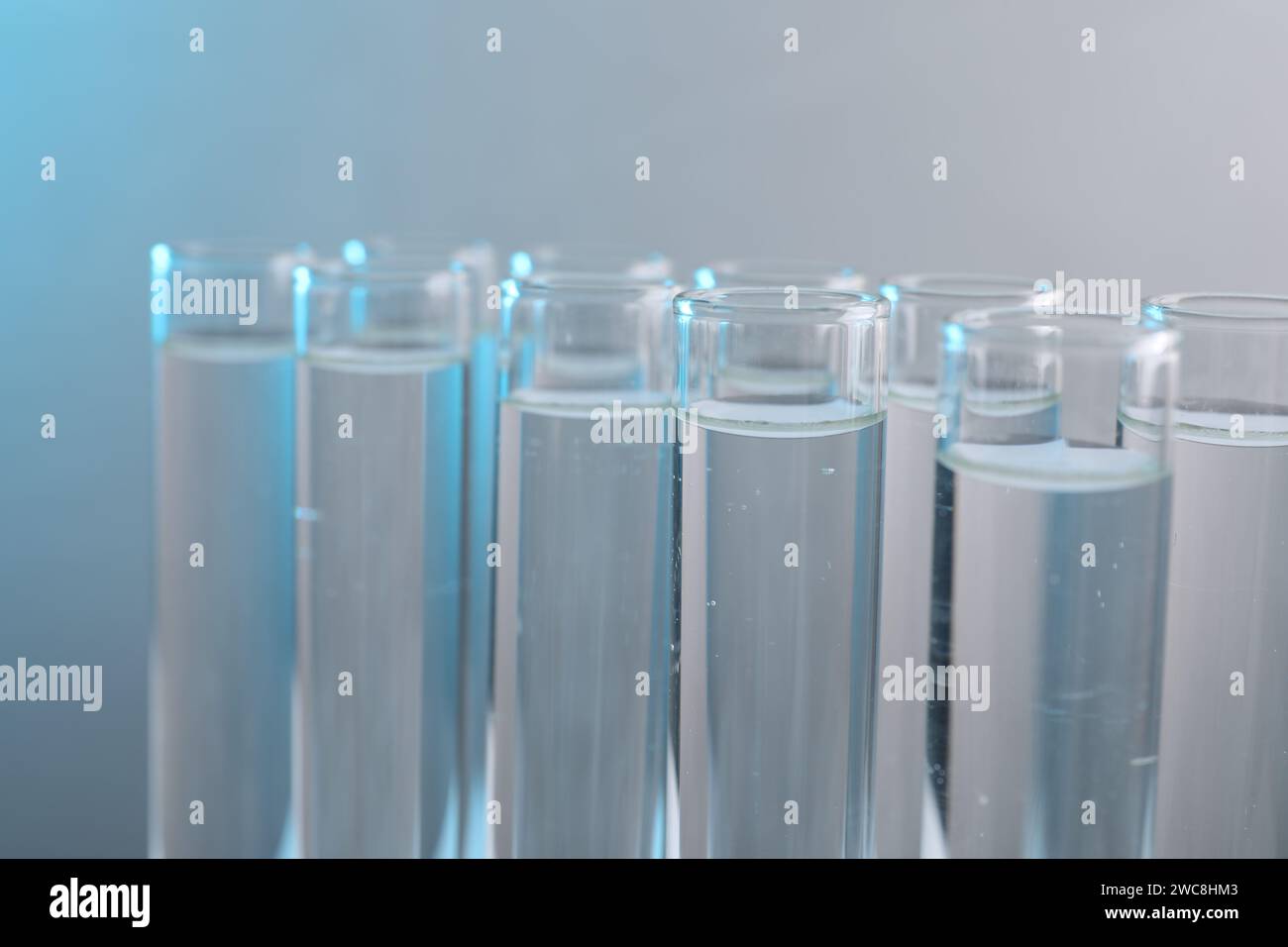 Laboratory analysis. Test tubes with liquid samples on color background ...