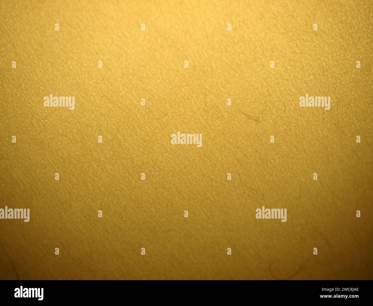 Yellow textile texture back lit by a lamp with traces of dirt. Work as ...
