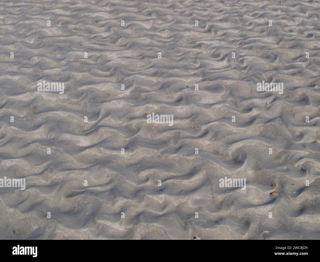 Beach sand texture resembling waves in a tropical beach Stock Photo - Alamy