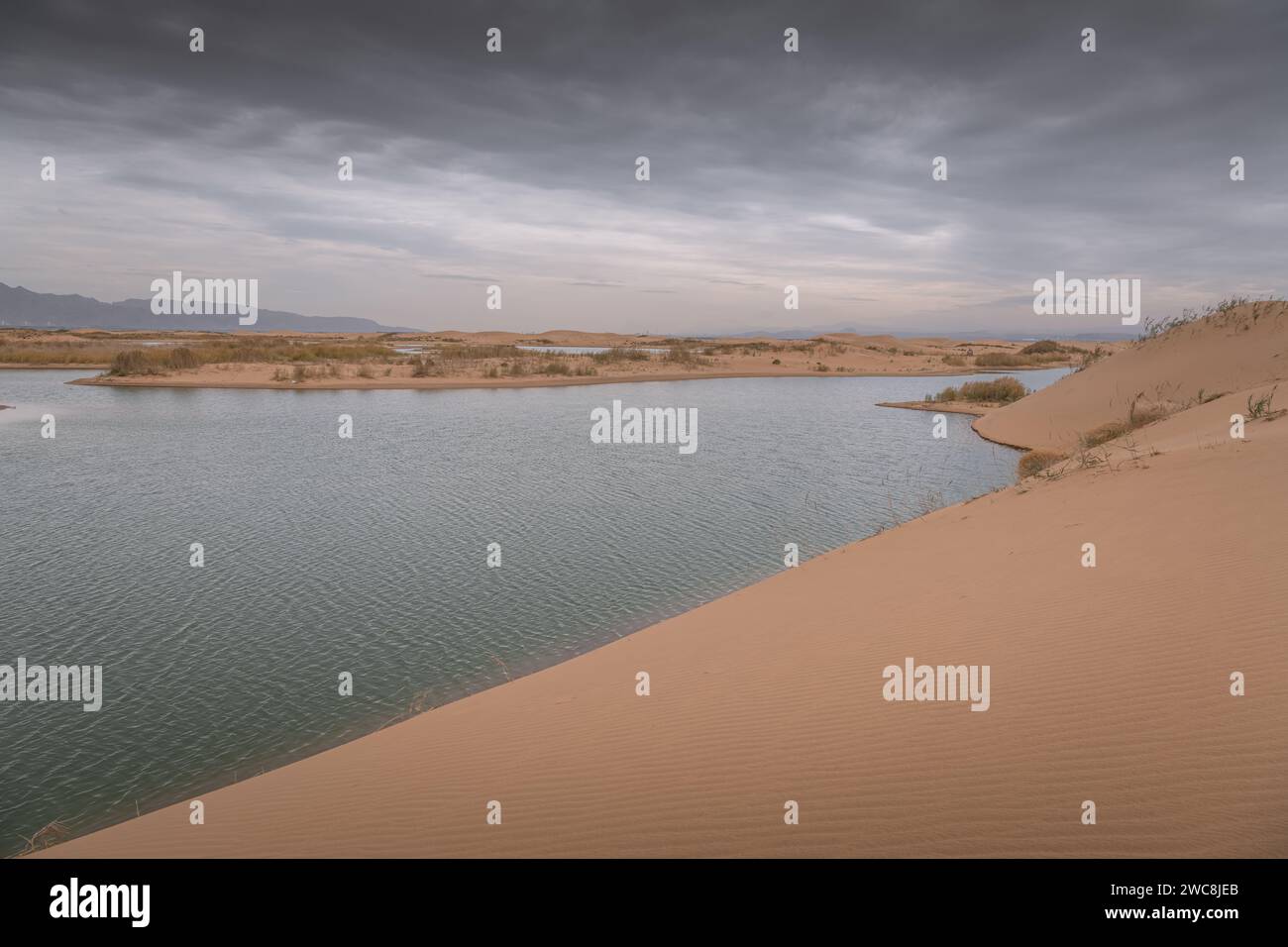 Desert vastness next to lake in Wuhai, Inner Mongolia, China. Dramatic ...