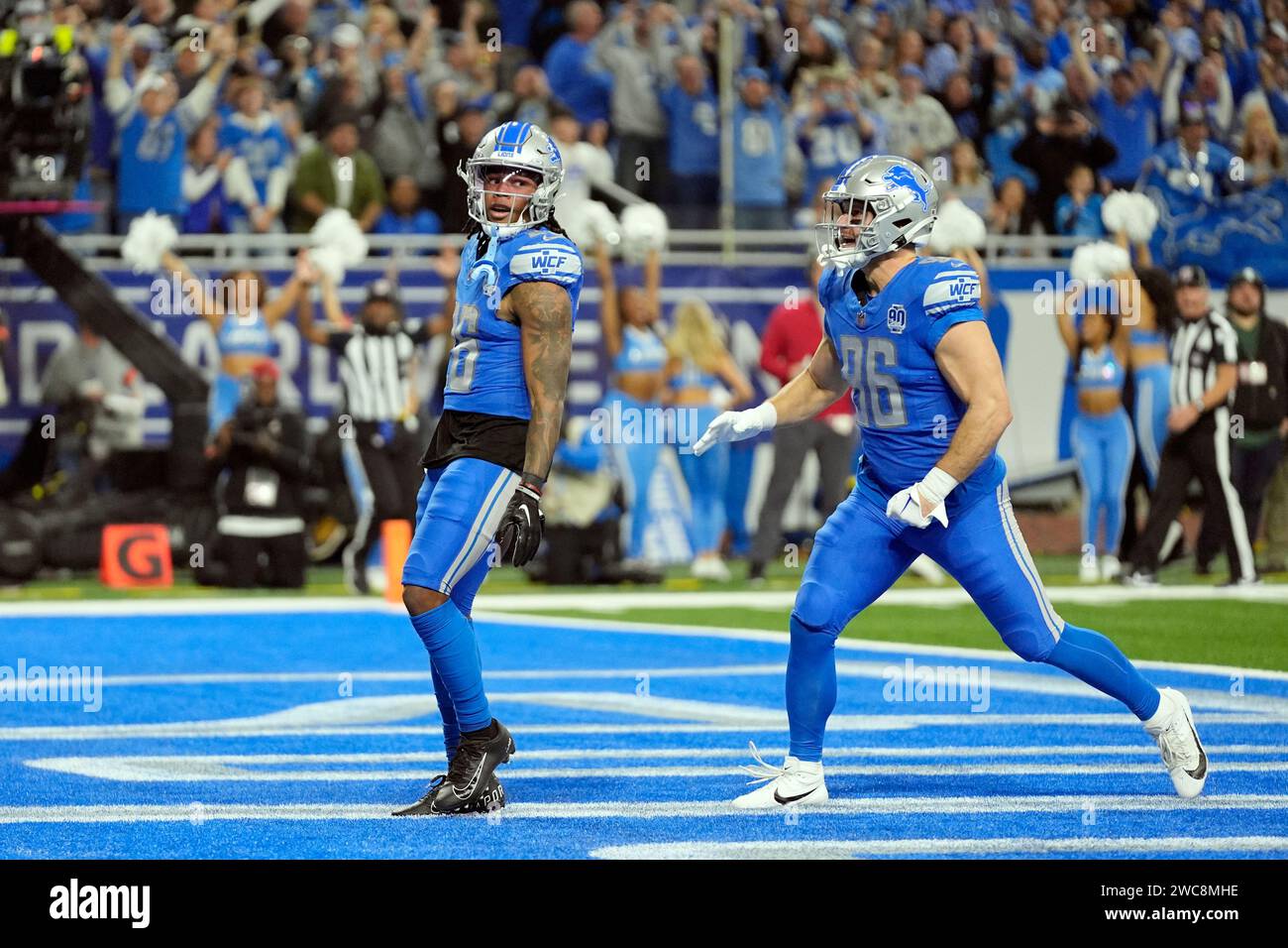 Detroit Lions running back Jahmyr Gibbs, let, is greeted by tight end ...