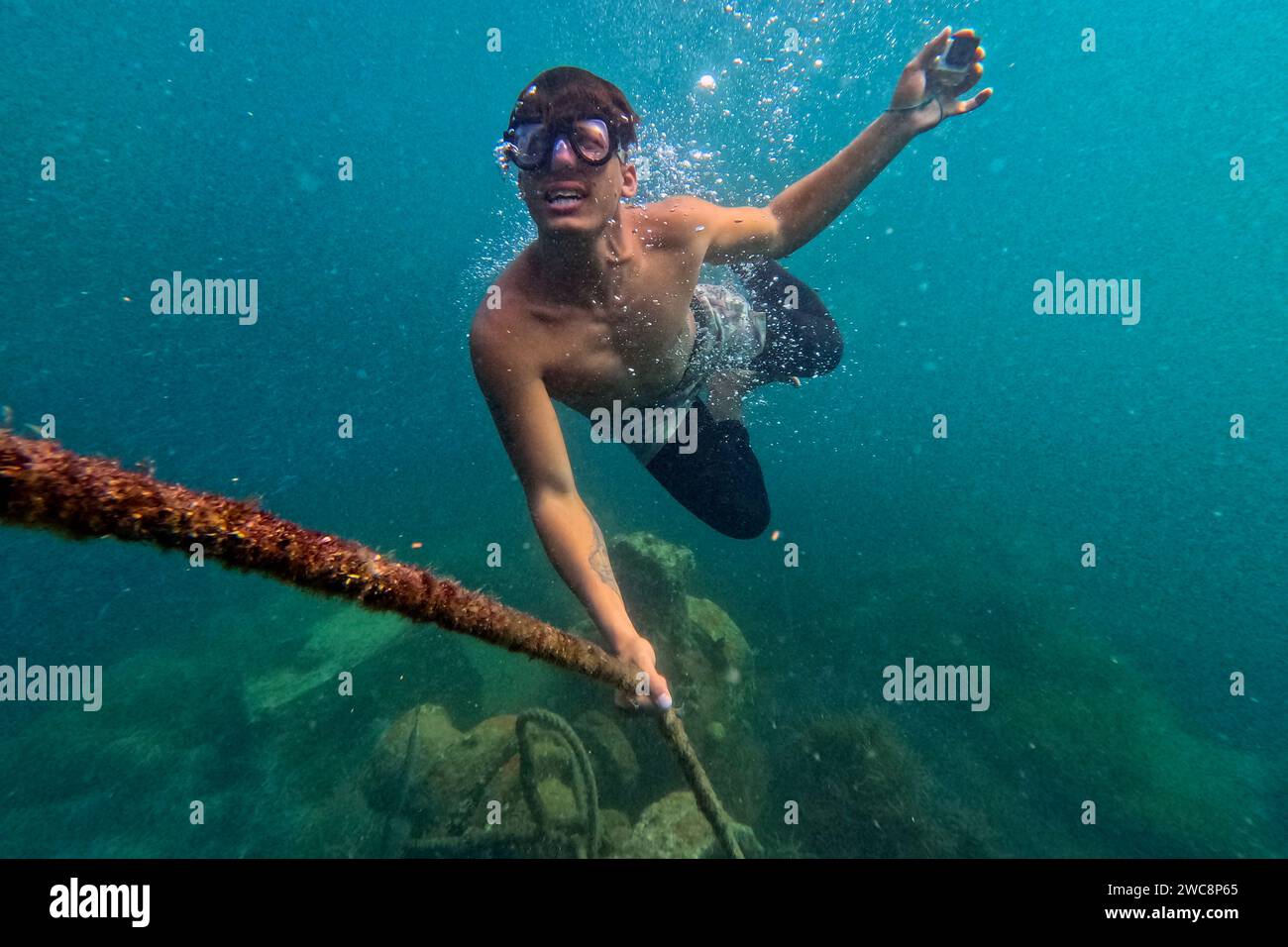 A swimmer gets a look at an underwater shipwreck off Cubagua Island ...