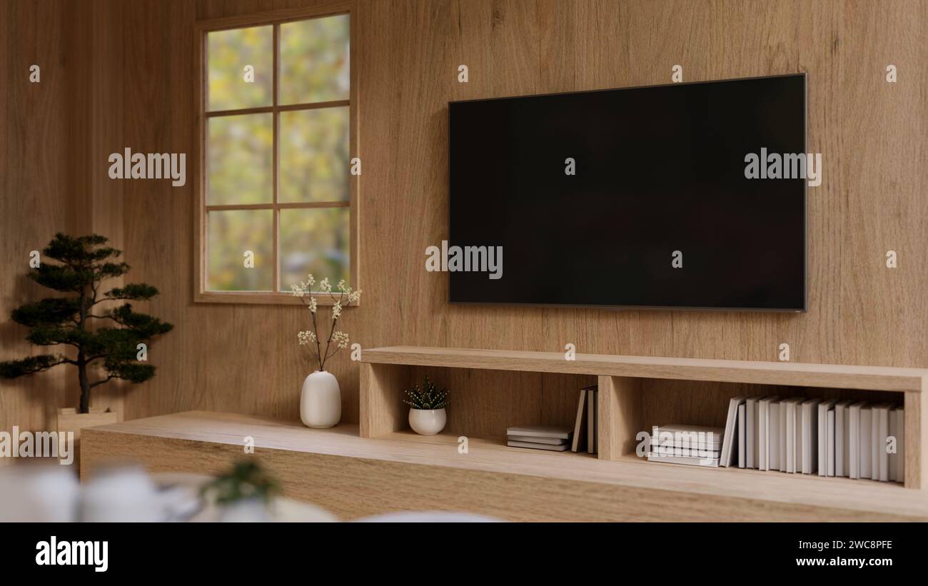 A modern TV monitor on a wooden wall above a wooden cabinet in a modern ...