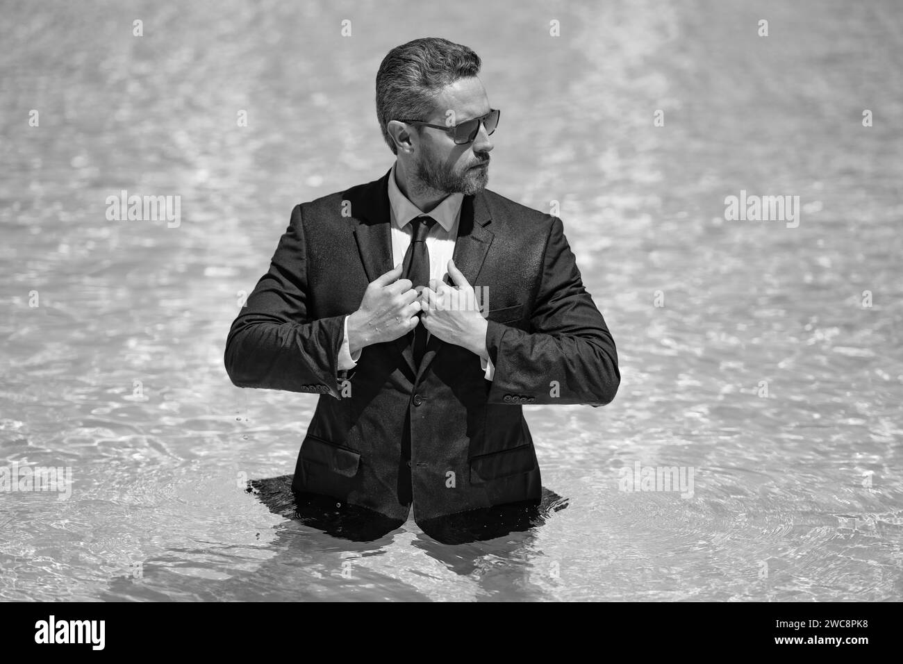 elegant businessman boss in summer pool wearing suit. photo of ...