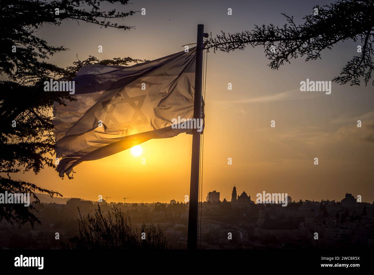 The Israeli flag (flag of Israel), the national symbol, is waving with ...