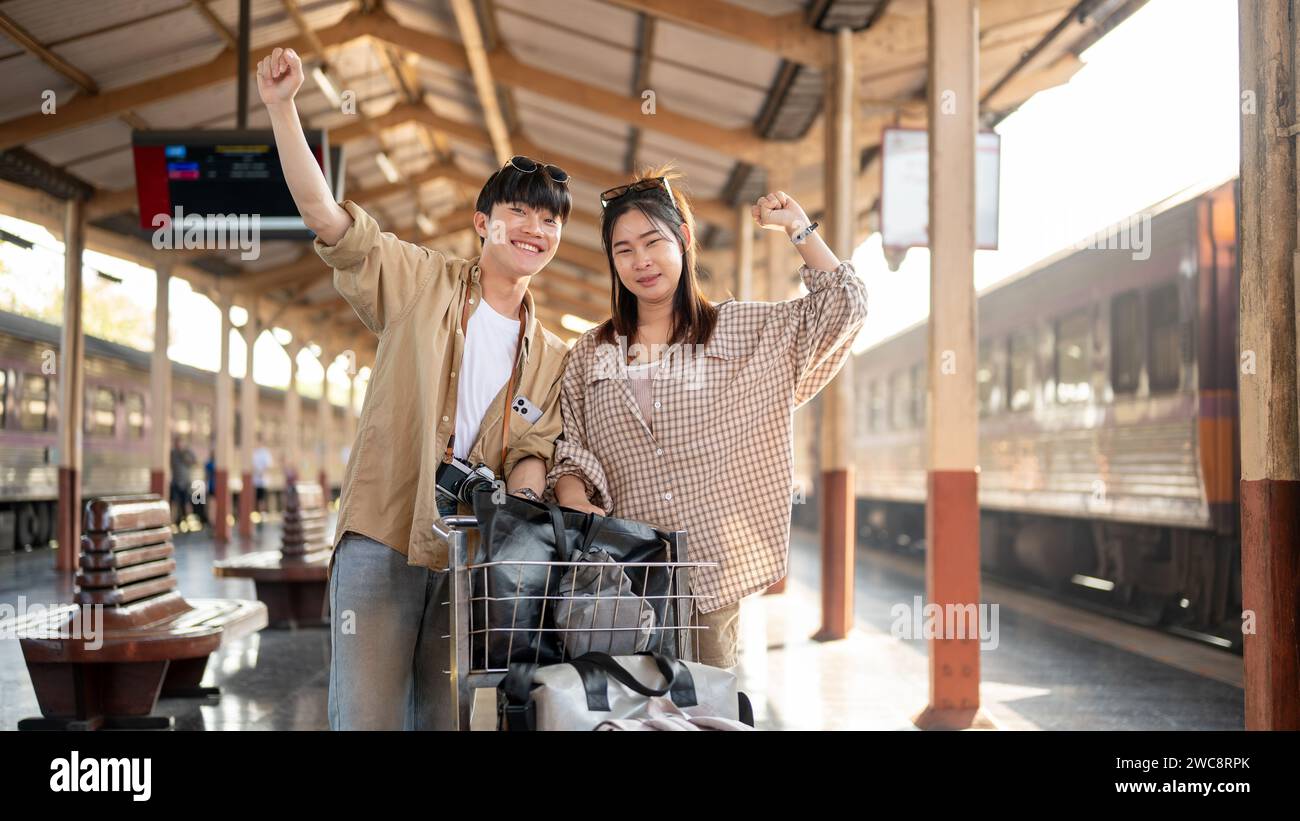 Cute and happy young Asian couple are excited for their summer vacation ...