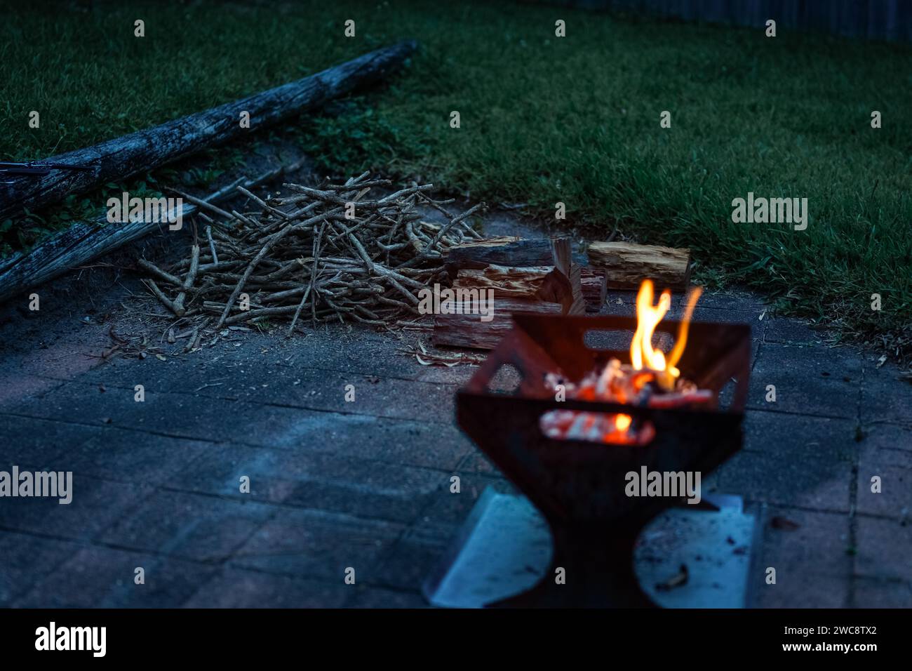 Campfire, fire pit filled with burnt wood and flames. Chopped fire wood ...