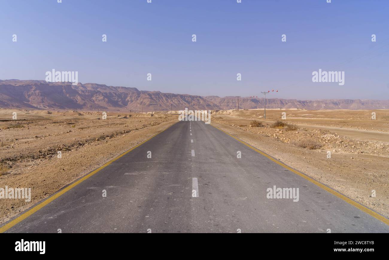 The scenic empty road going through Judean desert in the area of Masada ...