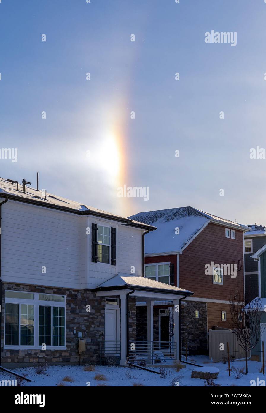 Sun Halo over the houses. Sun halo also known as sun bow or sun dog ...
