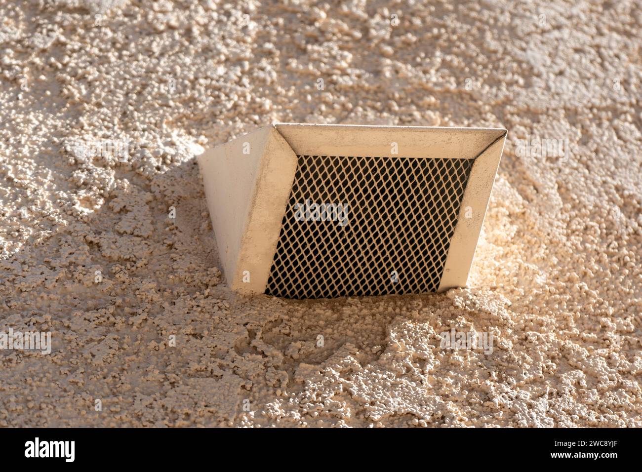Exterior wall air vent on beige stucco wall Stock Photo - Alamy