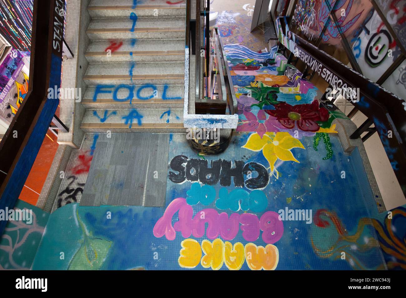 Top down view of old staircase that is painted in graffiti transforming ...