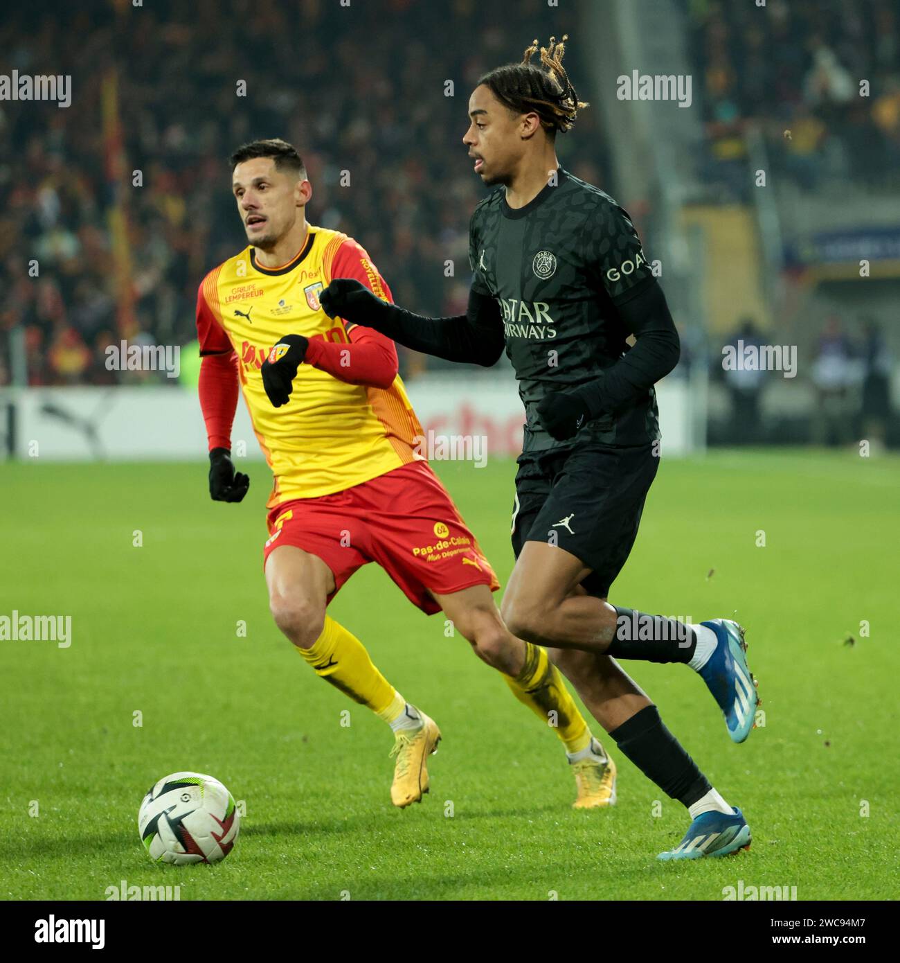 Lens, France. 14th Jan, 2024. Bradley Barcola of PSG, left Florian ...