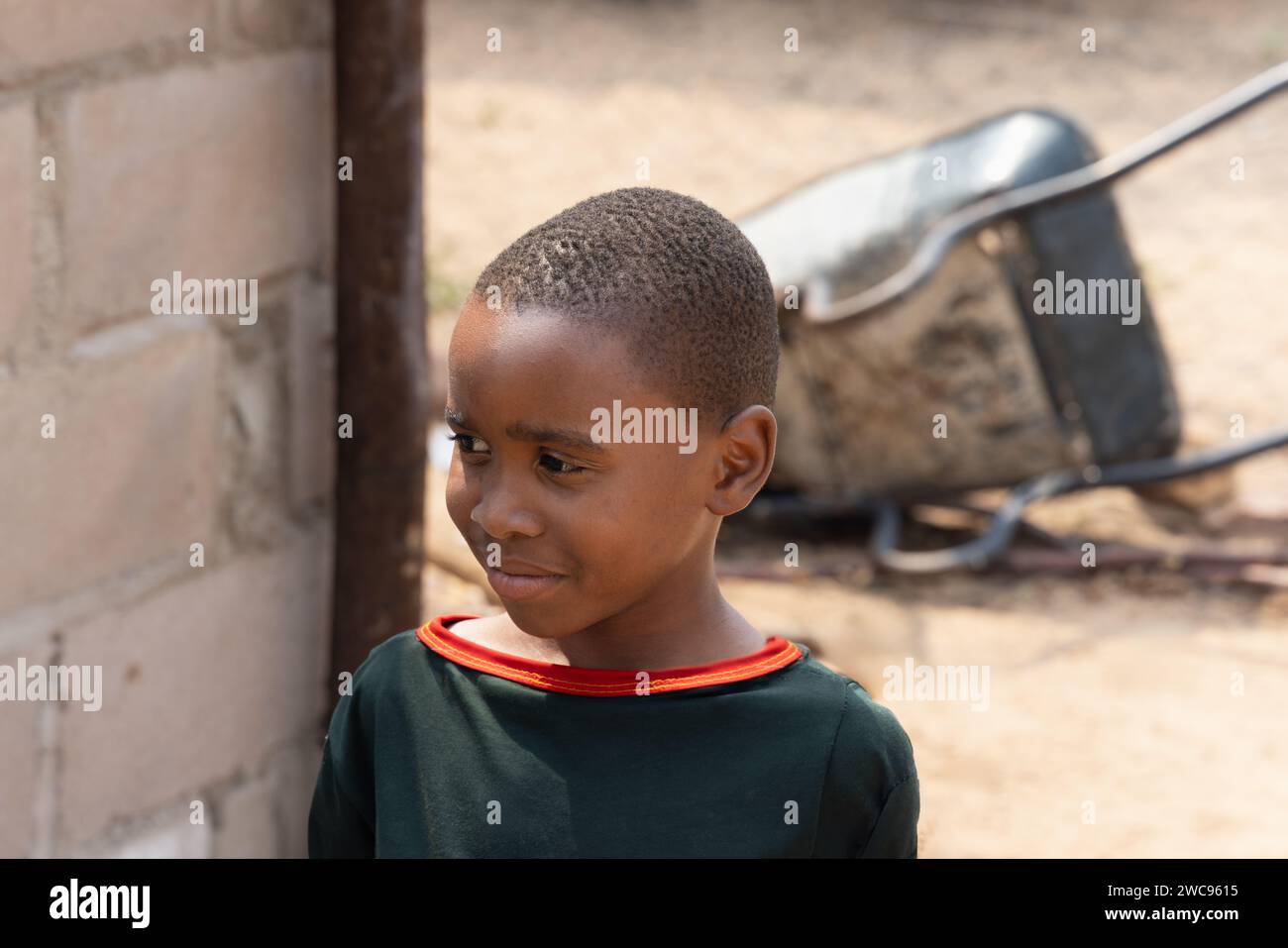 portrait of african child standing in the yard, village in Botswana ...