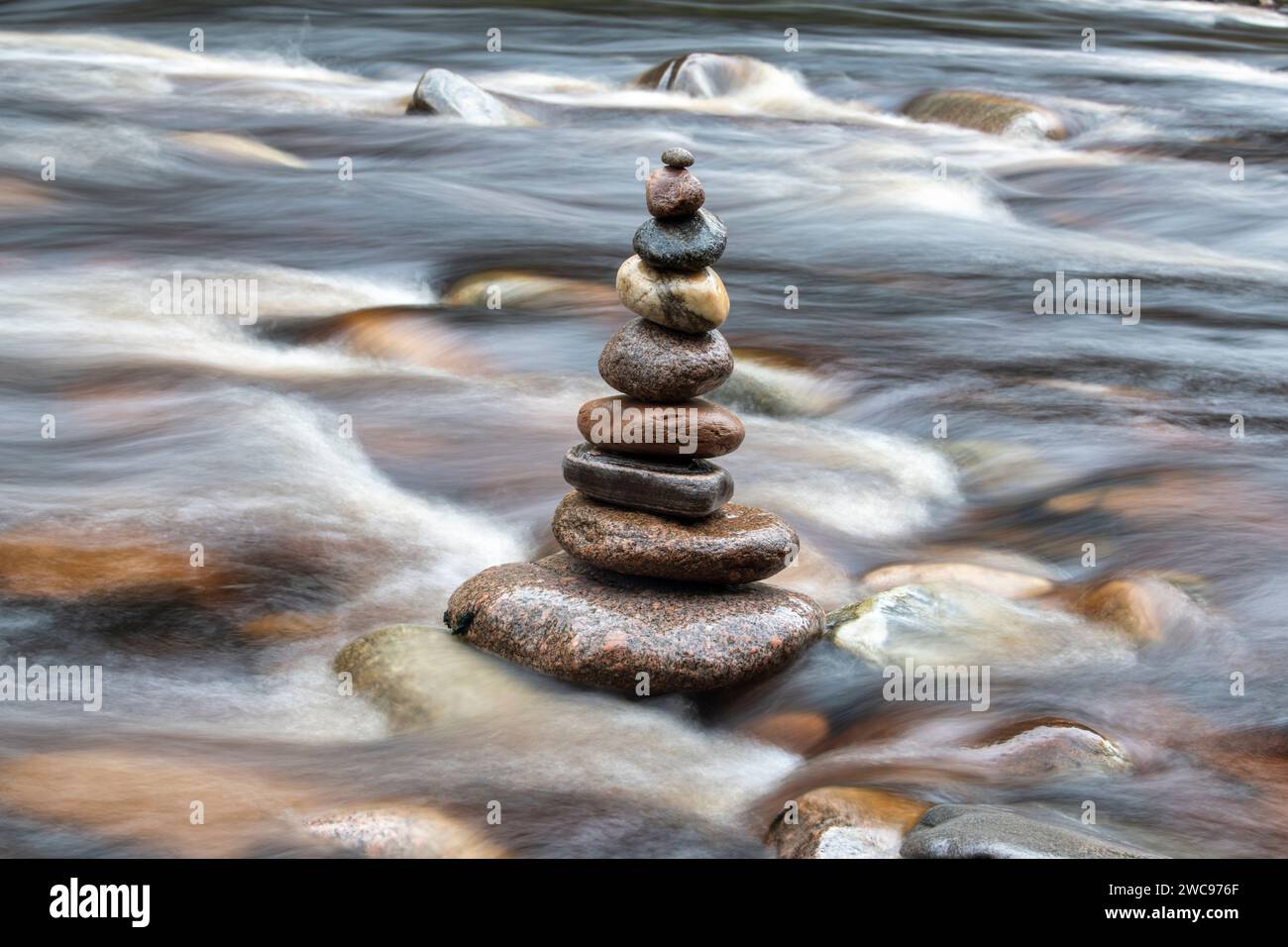 Stacked balanced stones in the Findhorn river in winter. Morayshire ...