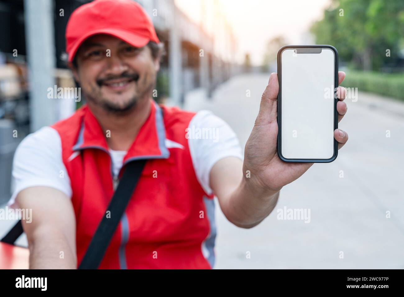 A food delivery driver showing the phone screen, inviting customers to ...
