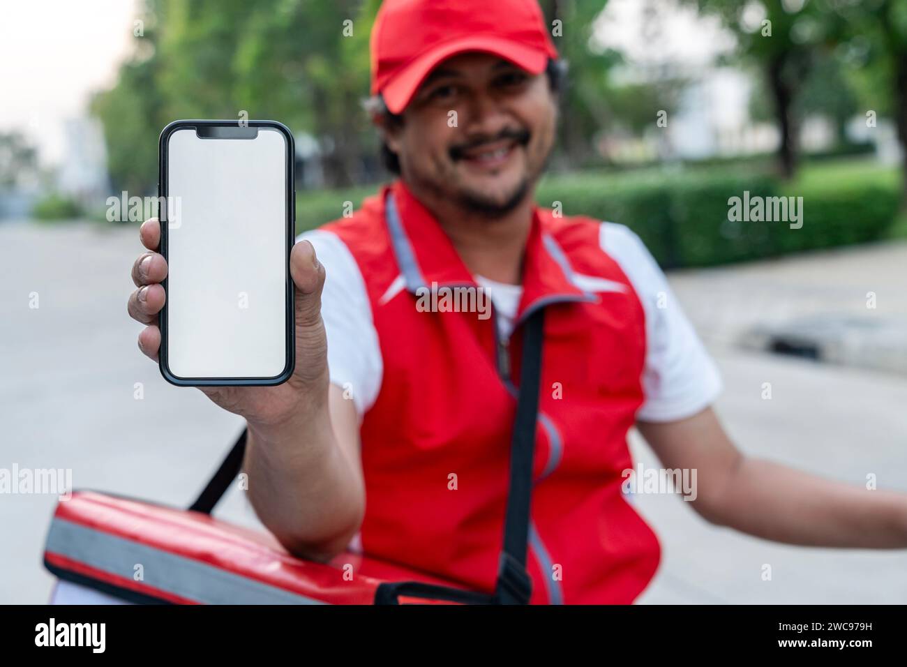 A food delivery driver showing the phone screen, inviting customers to ...
