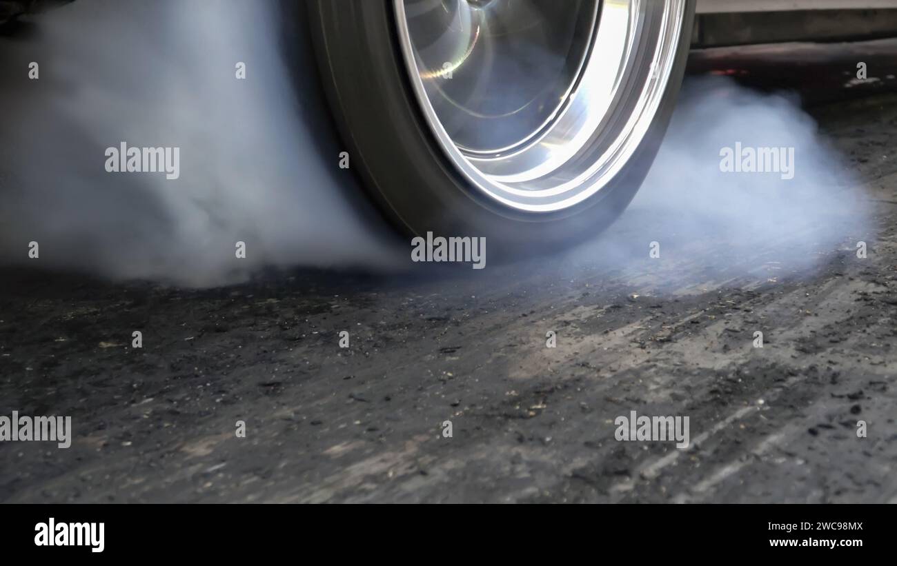 Drag racing car burning tire at starting line in race track Stock Photo ...