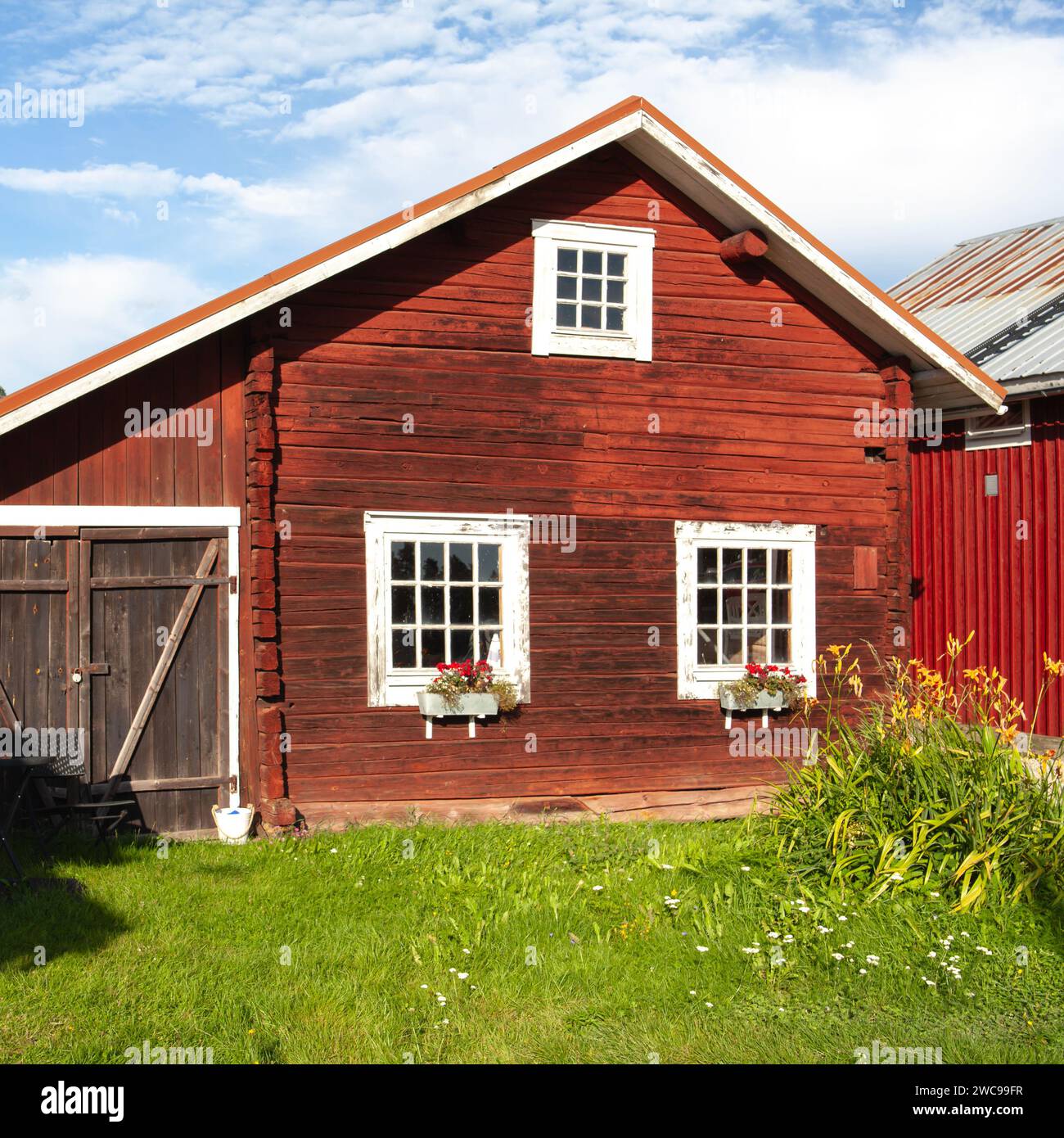 MELLANFJÄRDEN, SWEDEN ON AUGUST 14, 2023. Red wooden buildings by the ...