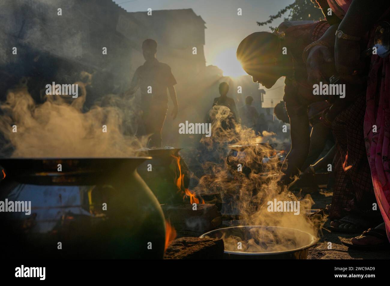 Indian Tamil Hindu women offer prayers as they cook special food to ...