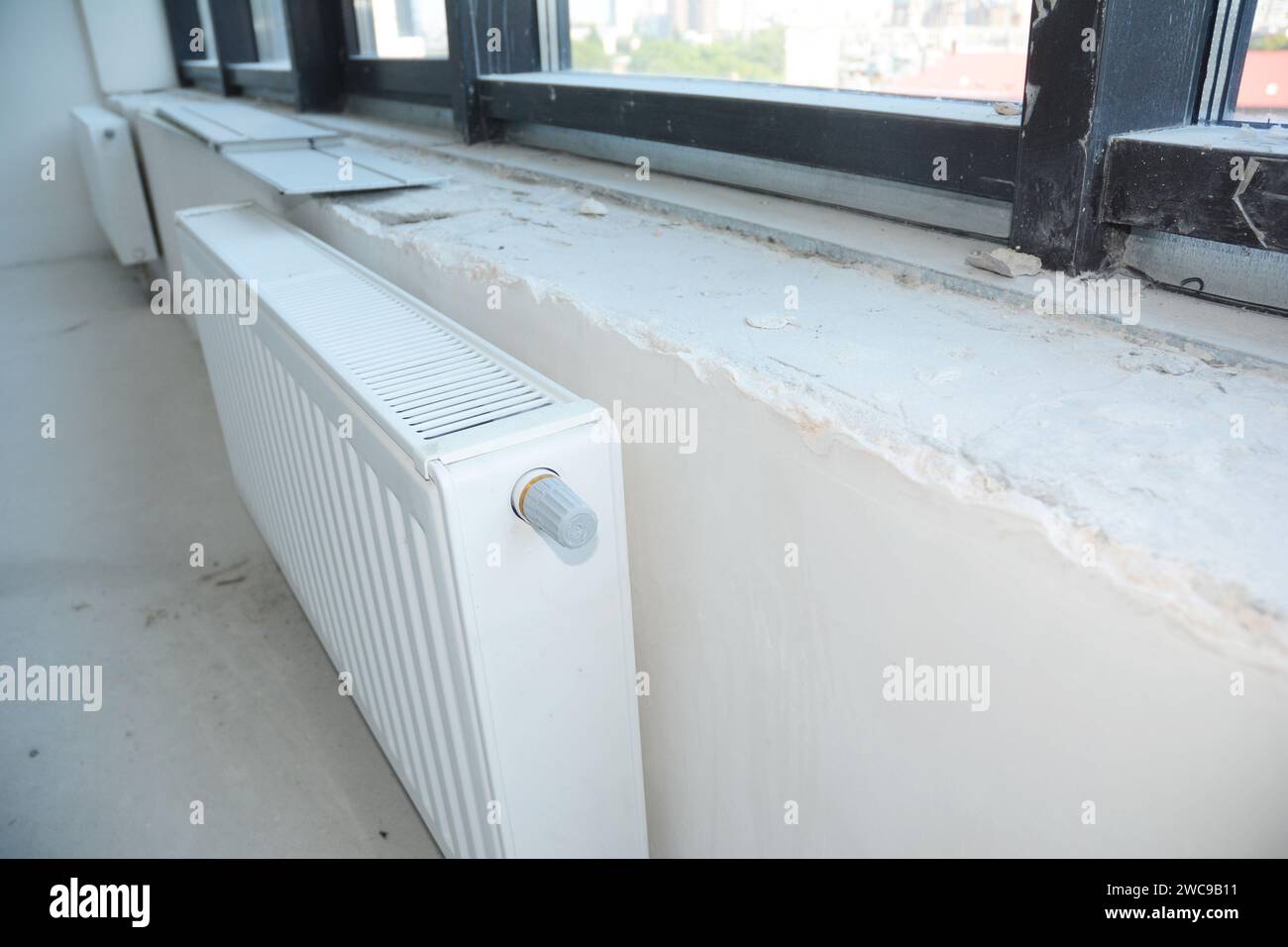 Home radiator heating. New radiators installation on the wall near a ...