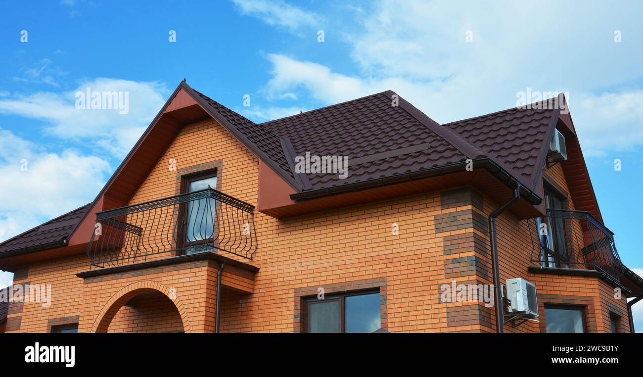 Valley and gable brick house roofing construction with attic windows ...