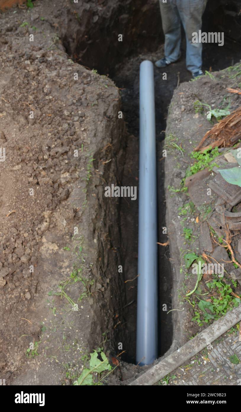 Installation of main drain pipe, sewer waste line, septic pipe in a ...