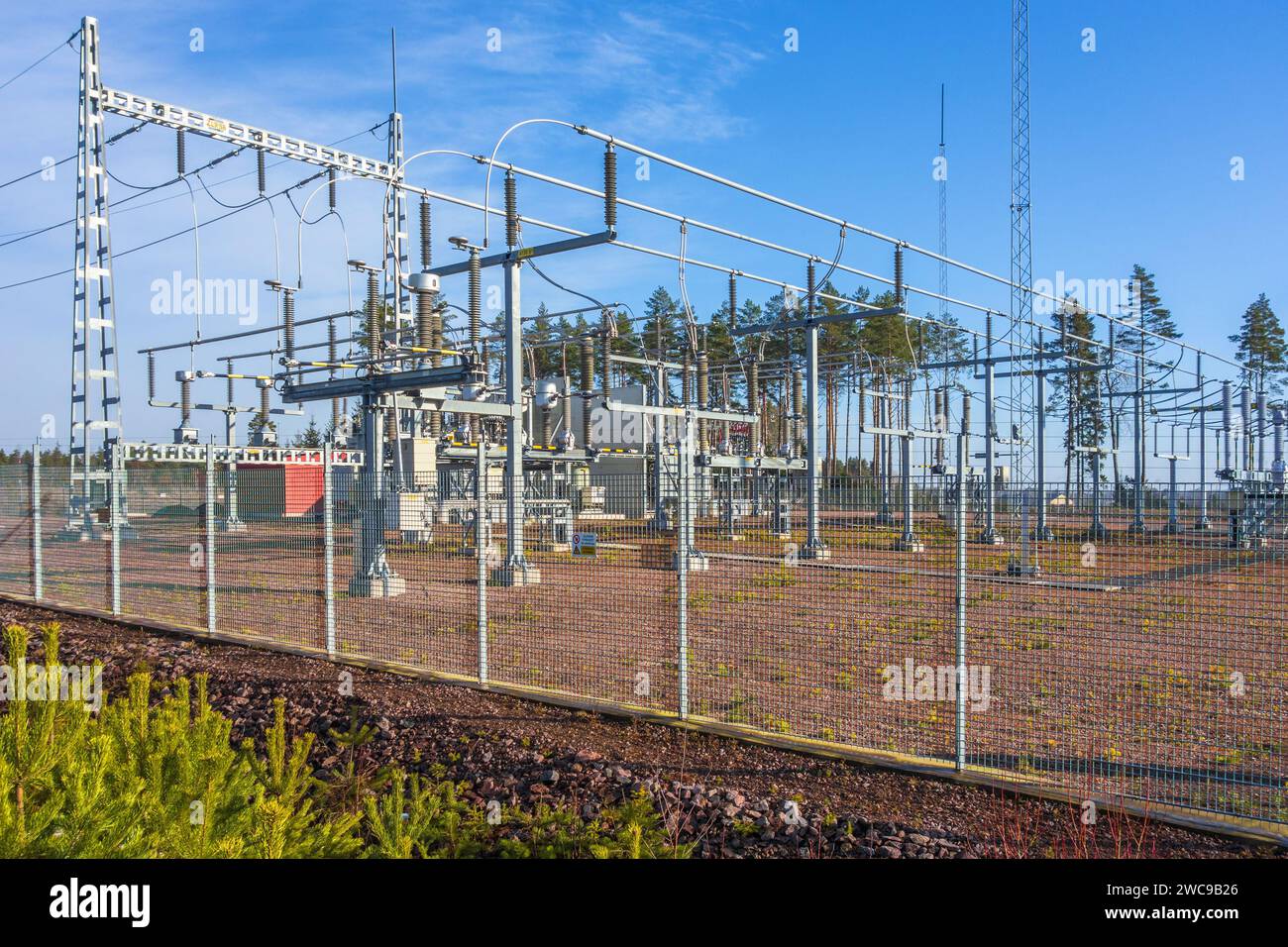 Electrical substation with a fence by a forest Stock Photo - Alamy