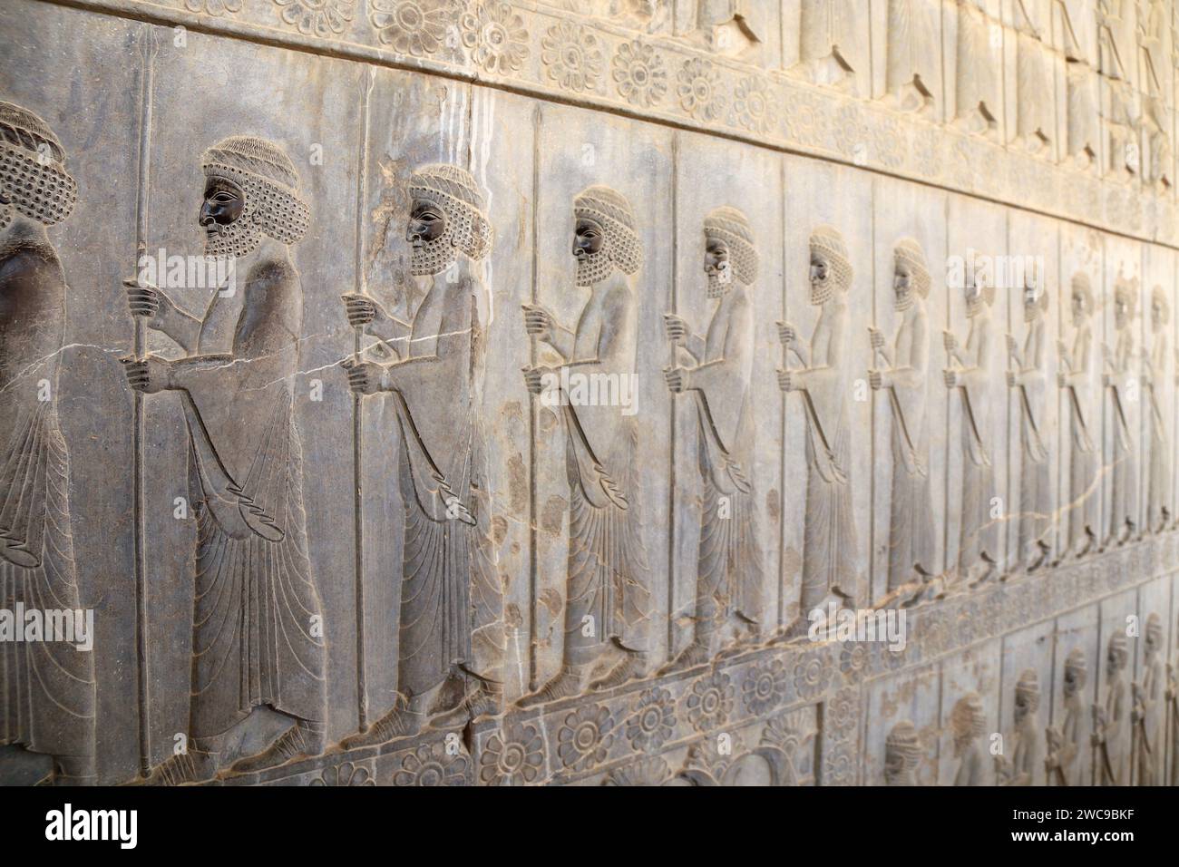 Ancient wall with bas-relief with assyrian warriors with spears ...